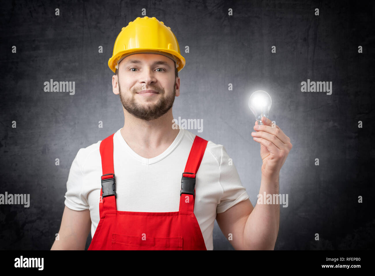 Construction worker with a glowing light bulb Stock Photo - Alamy