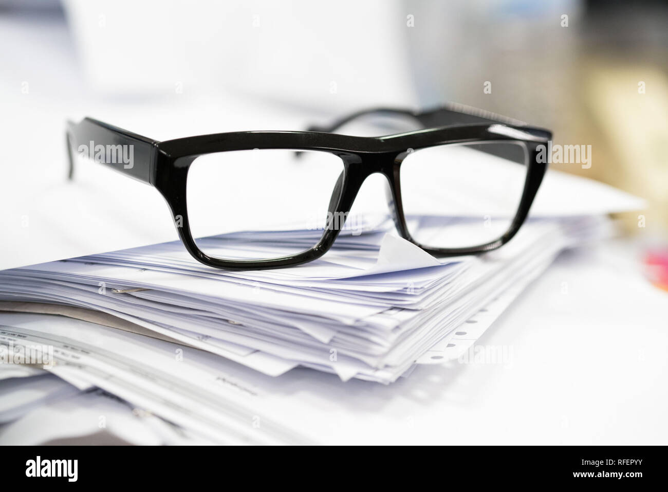 Paper heap from hard work is under black glass Stock Photo - Alamy