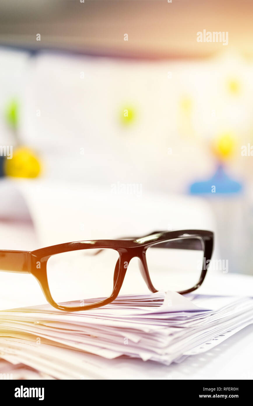 Paper heap from hard work is under black glass Stock Photo - Alamy