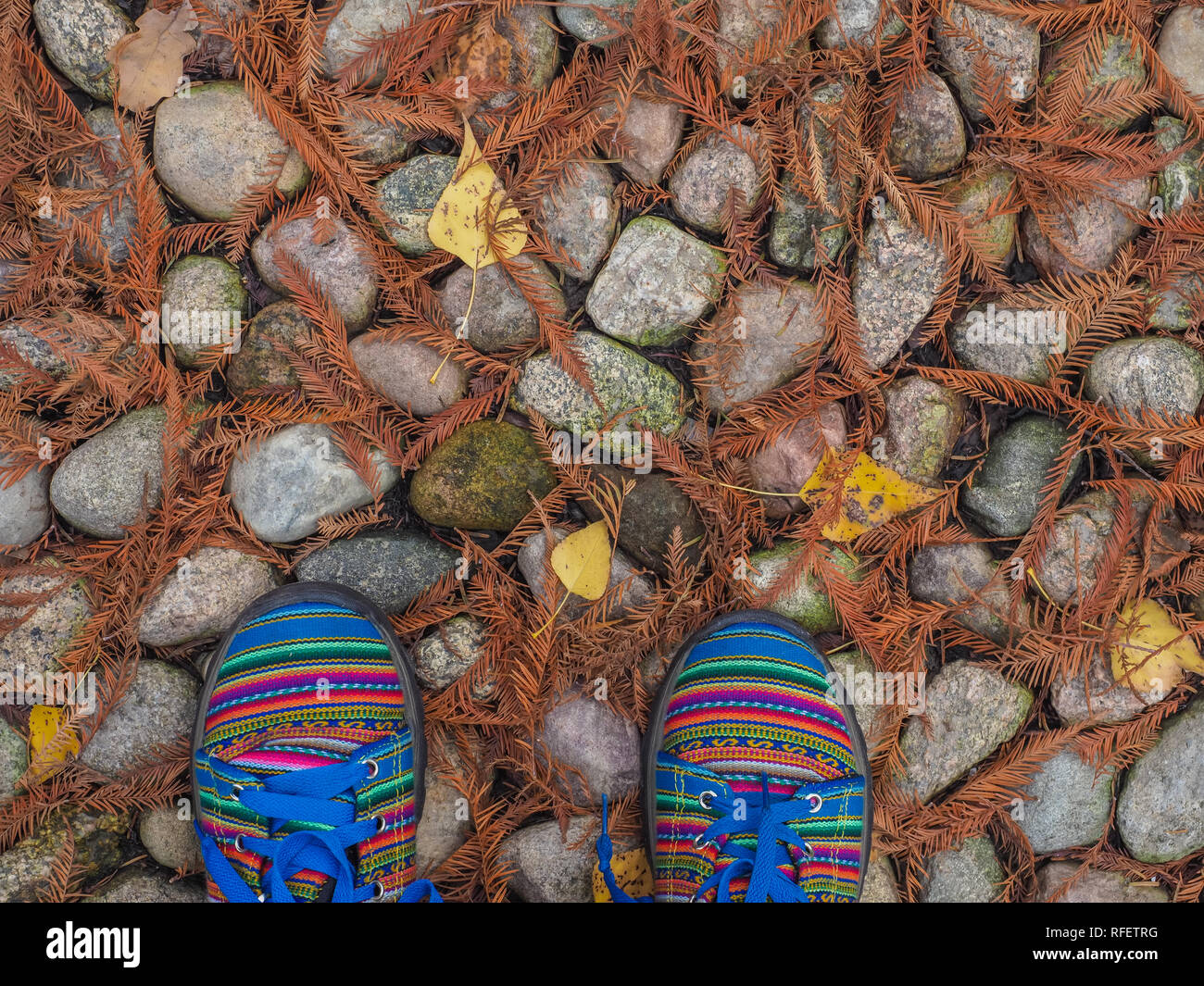 Peruvian, colorful shoes on a background of stones covered with brown ...