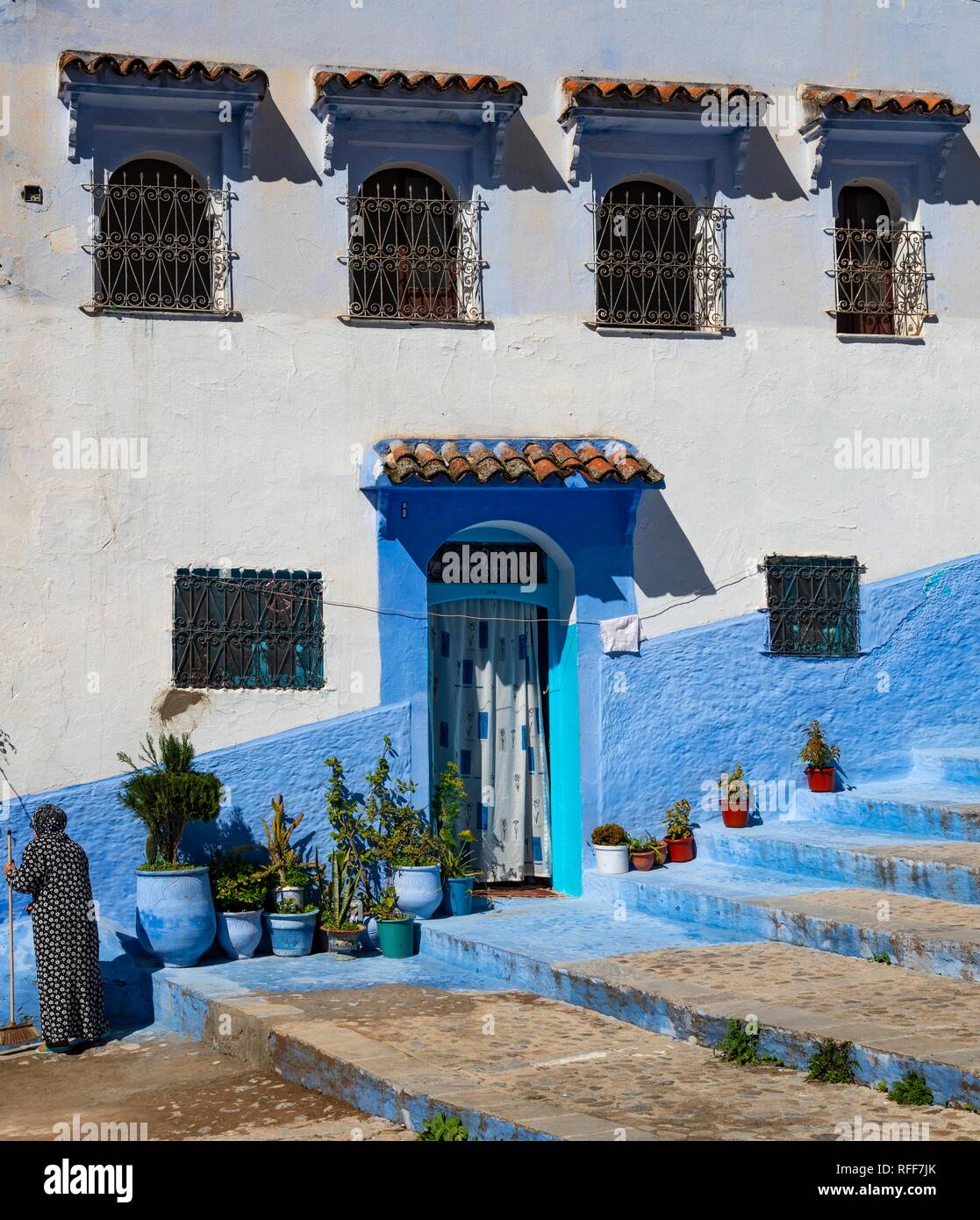 Facade, entrance with flower pots, blue house, medina of Chefchaouen ...