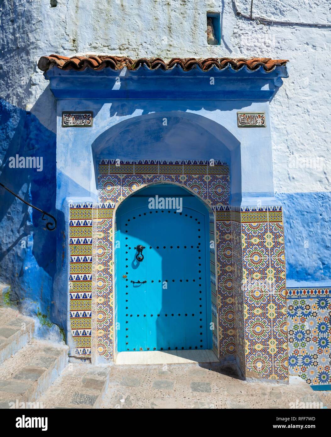 Façade, blue entrance door with colourful patterned tiles, blue house ...