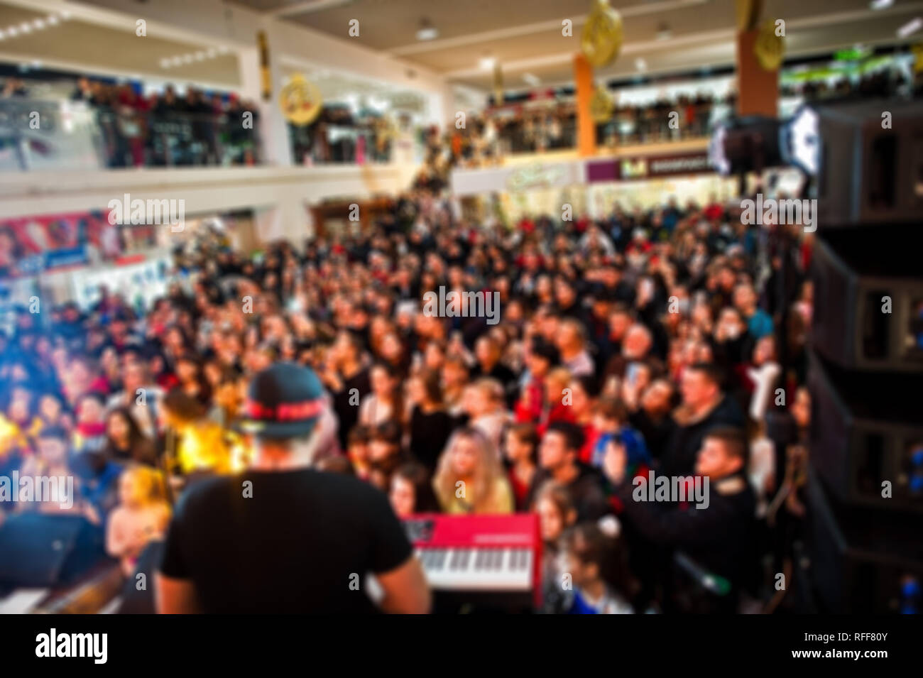 Blured photo crowded concert hall with scene stage lights with people ...