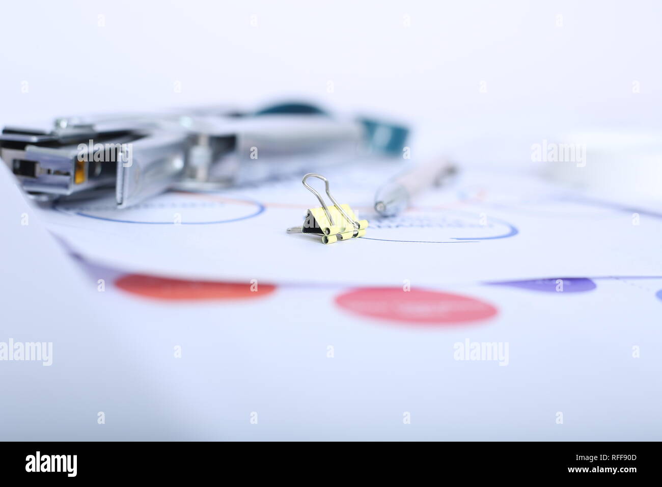 Picture of stapler and paper clip on the paper Stock Photo - Alamy
