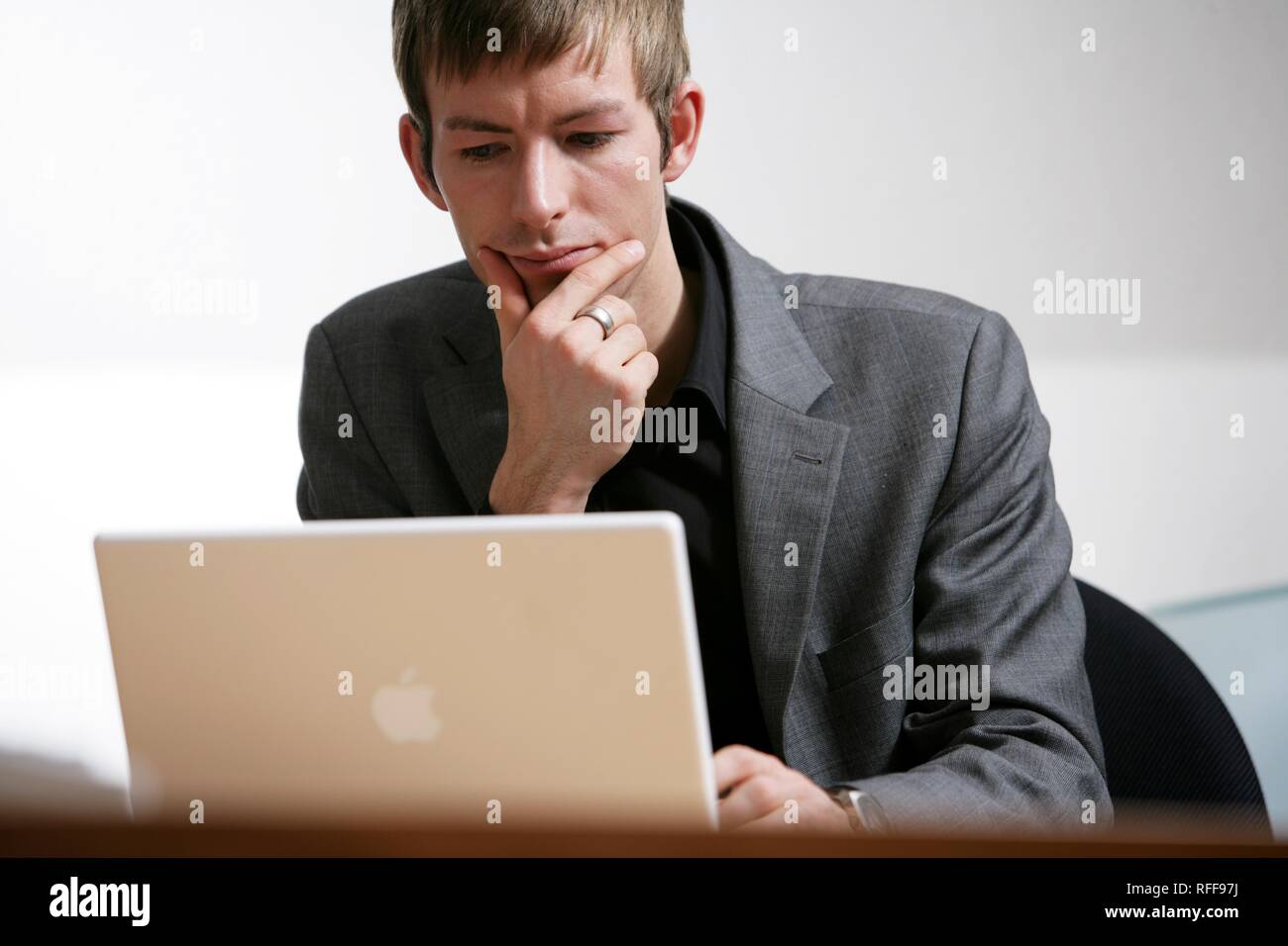 DEU, Germany : Young man is working at his laptop computer, Apple Stock ...