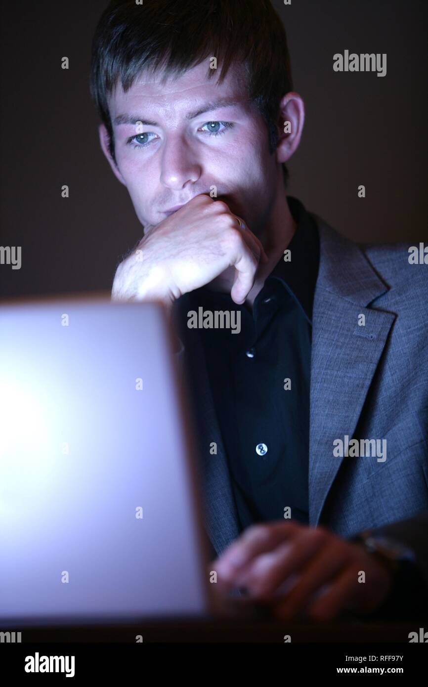 DEU, Germany : Young man is working at his laptop computer Stock Photo ...