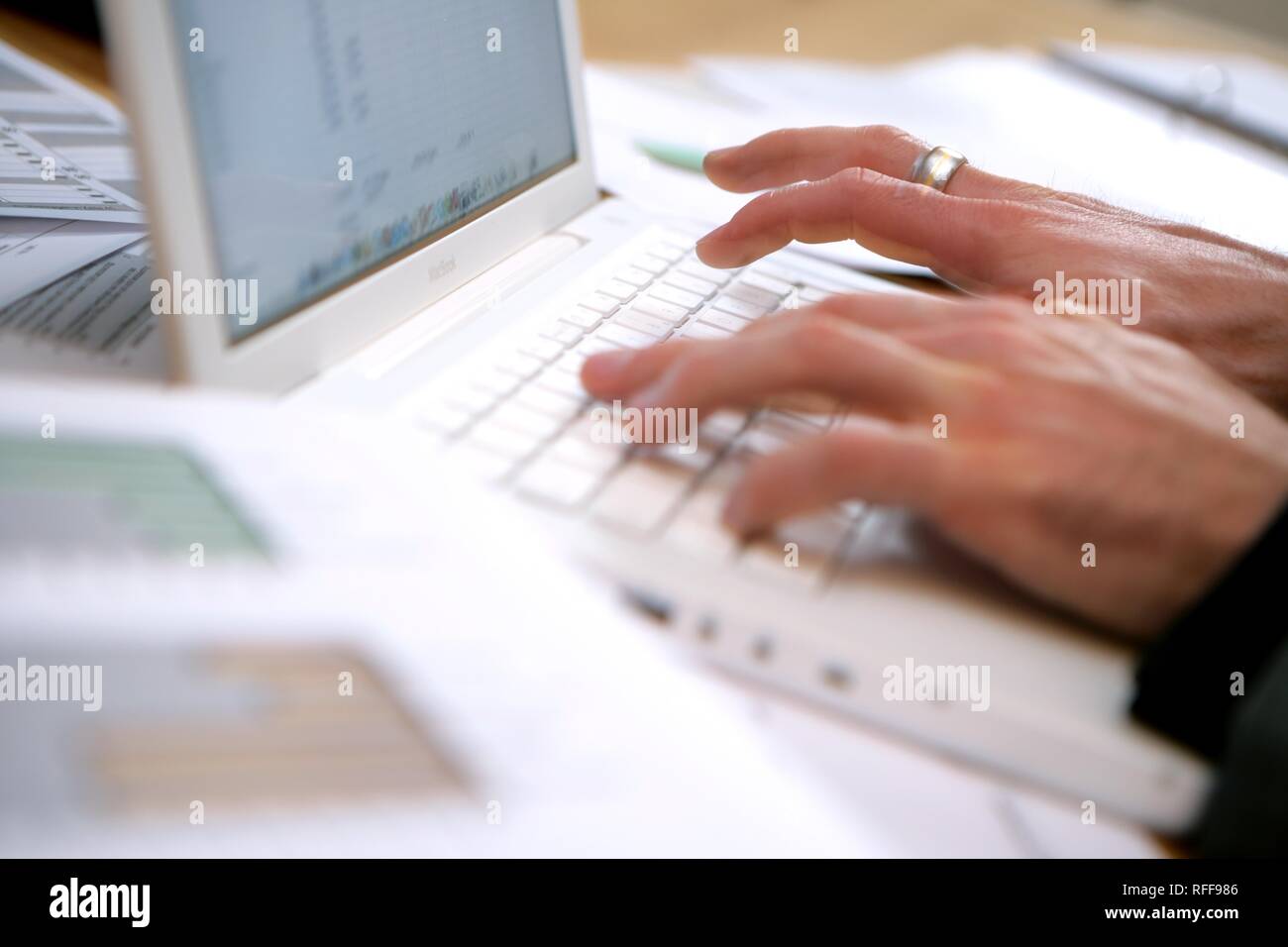 DEU, Germany : Young man is working at his laptop computer Stock Photo ...