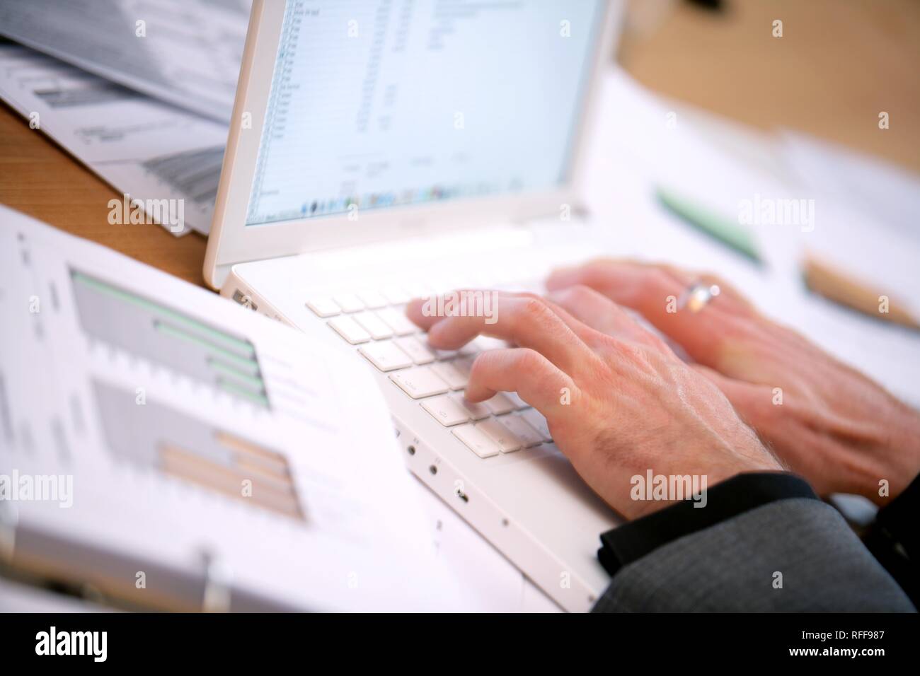 DEU, Germany : Young man is working at his laptop computer Stock Photo ...