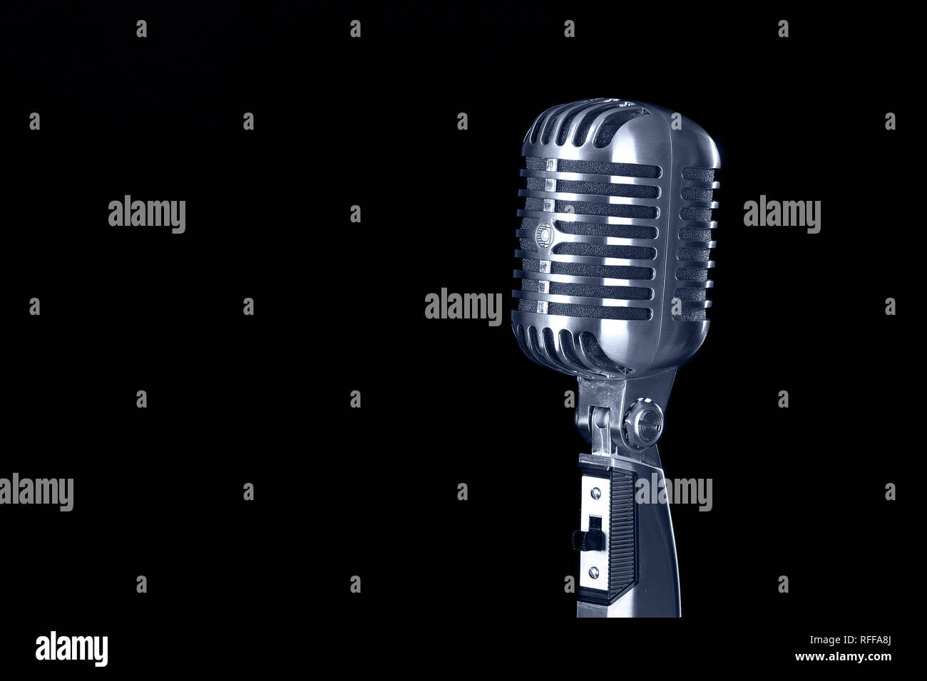 Vintage microphone against black background Stock Photo - Alamy