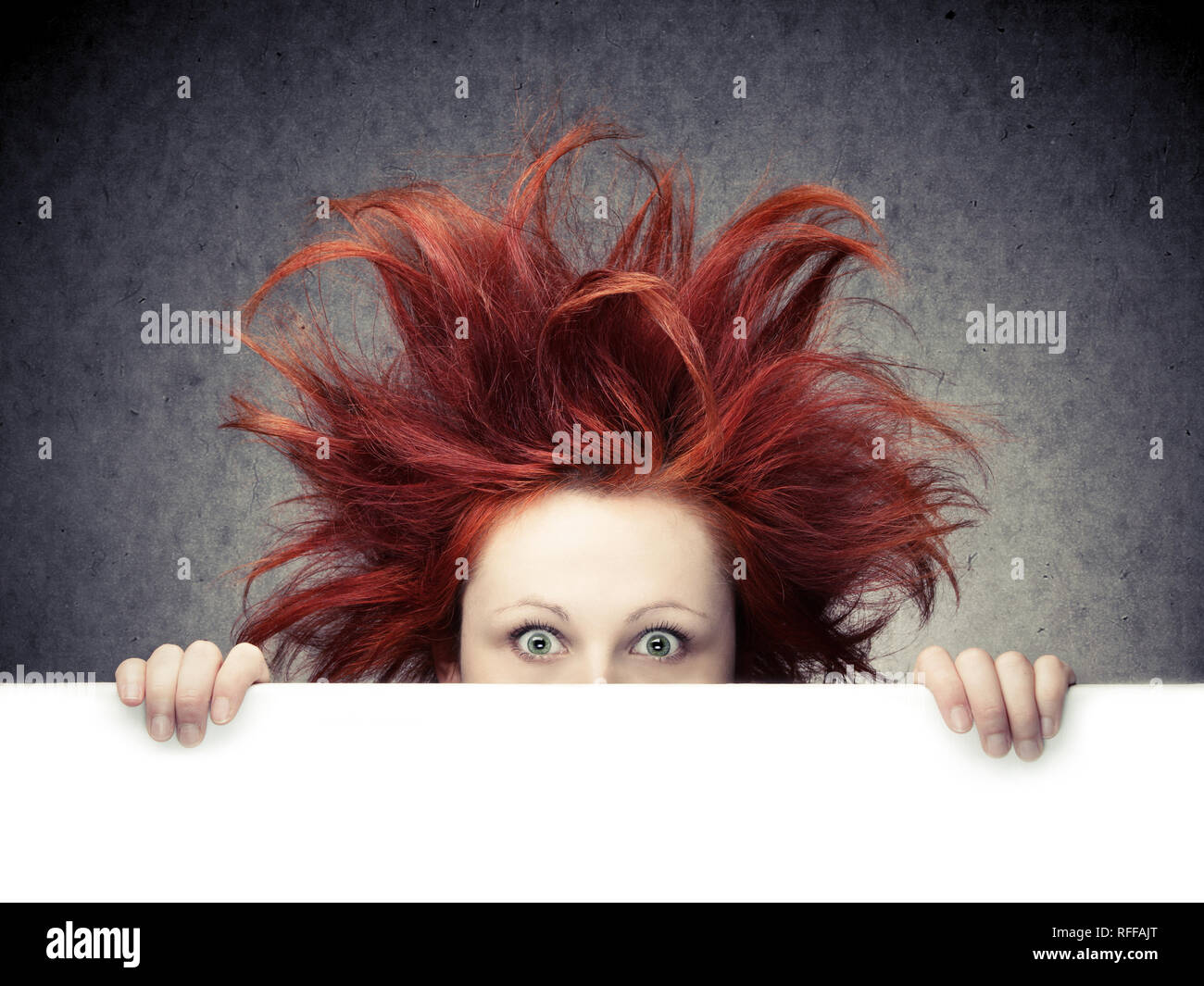 Redhead woman with messy hair against gray background Stock Photo - Alamy