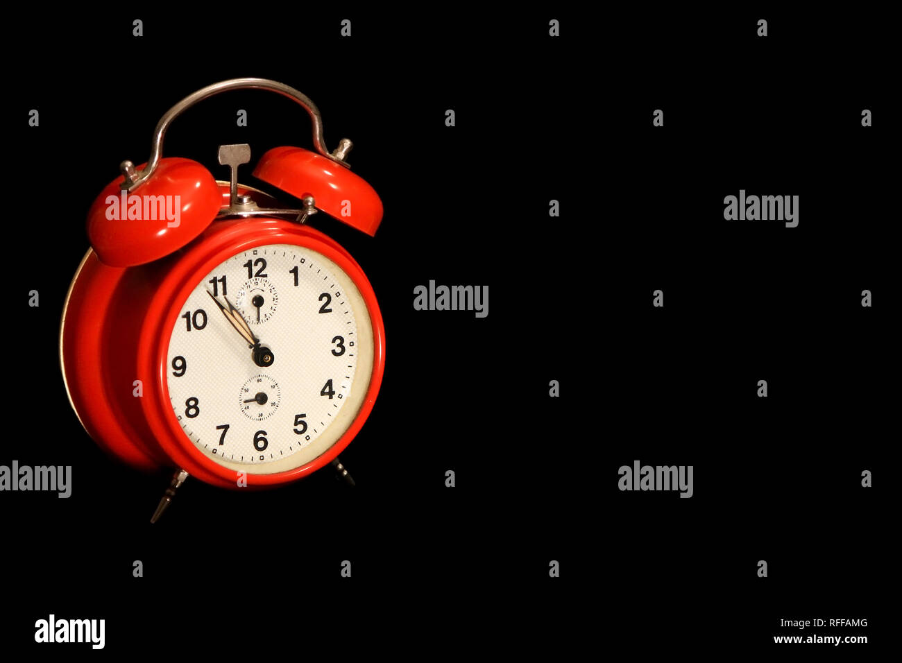 Red alarm clock on black background Stock Photo - Alamy