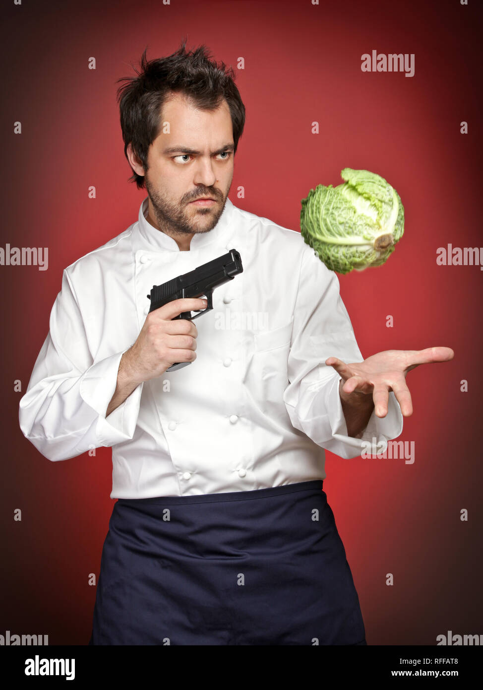 Male cook with gun pointing at savoy cabbage Stock Photo - Alamy