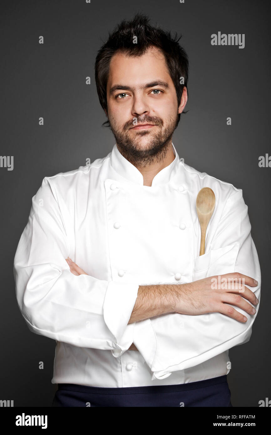 Handsome chef posing with hands crossed Stock Photo - Alamy