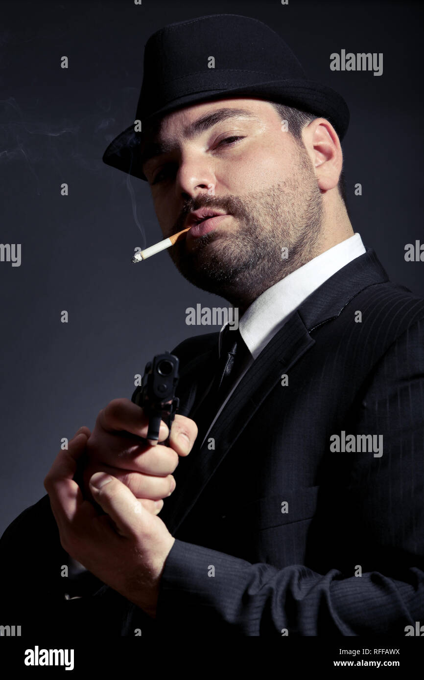 Dangerous man in suit with a gun Stock Photo - Alamy
