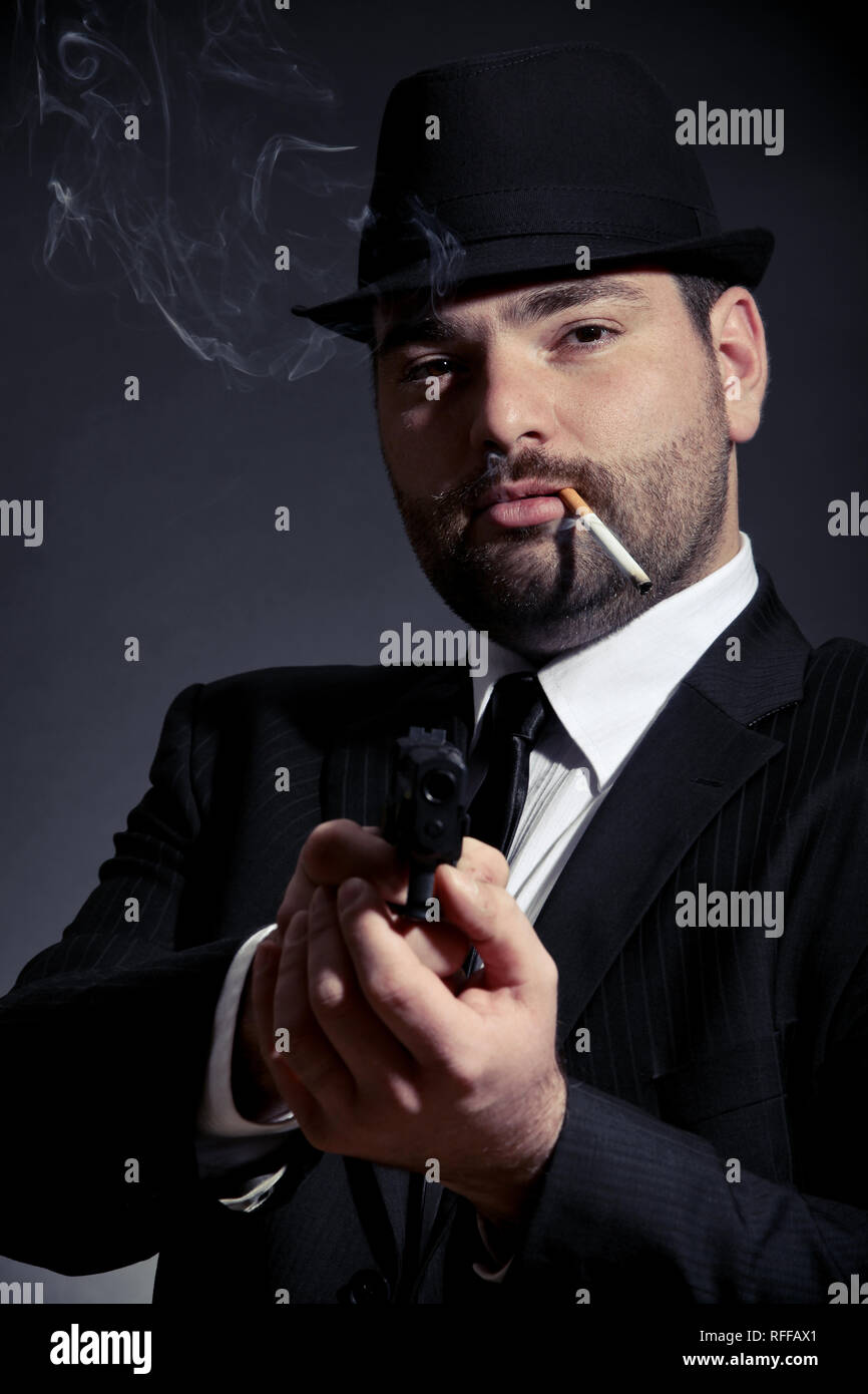Dangerous man in suit with a gun Stock Photo - Alamy