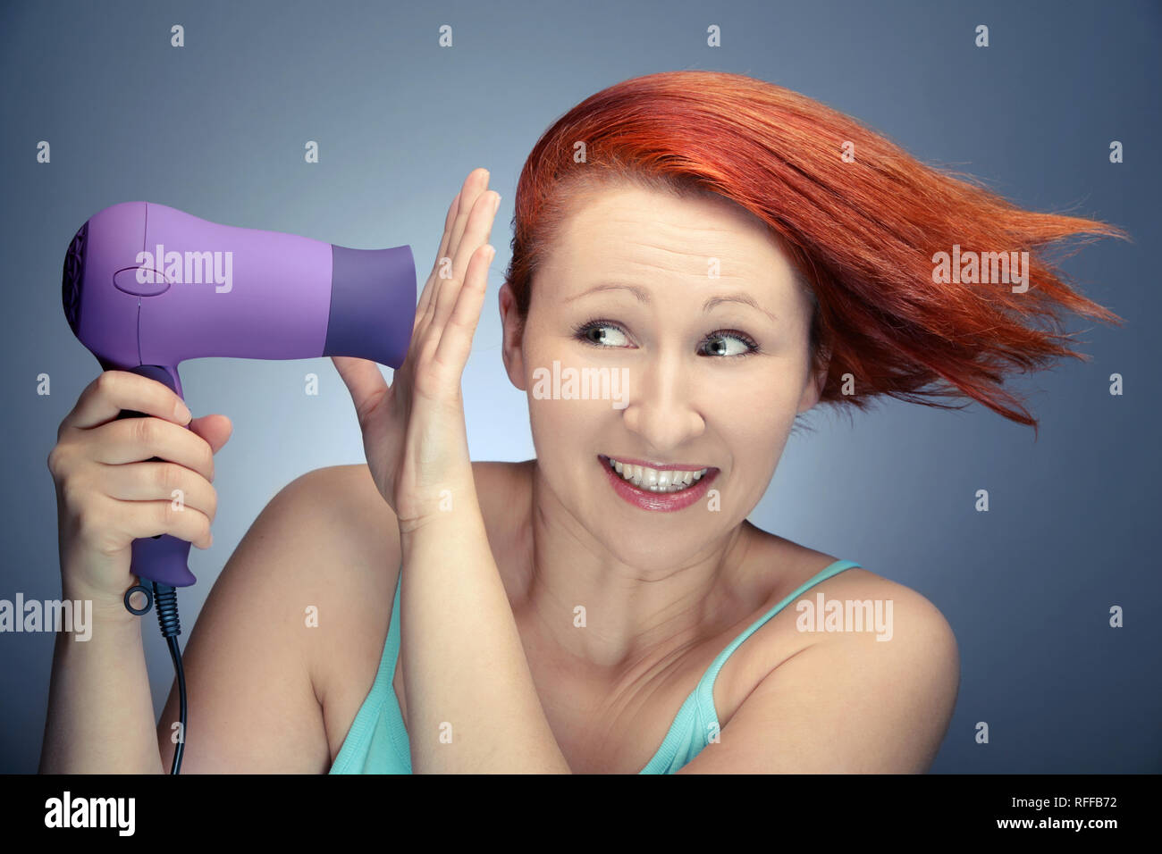 Cure redhead woman drying her hair Stock Photo - Alamy