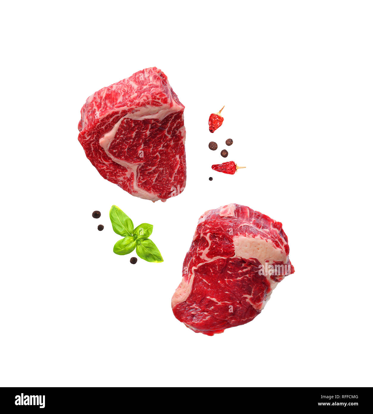 Raw marbled ribeye steaks isolated on white Stock Photo - Alamy