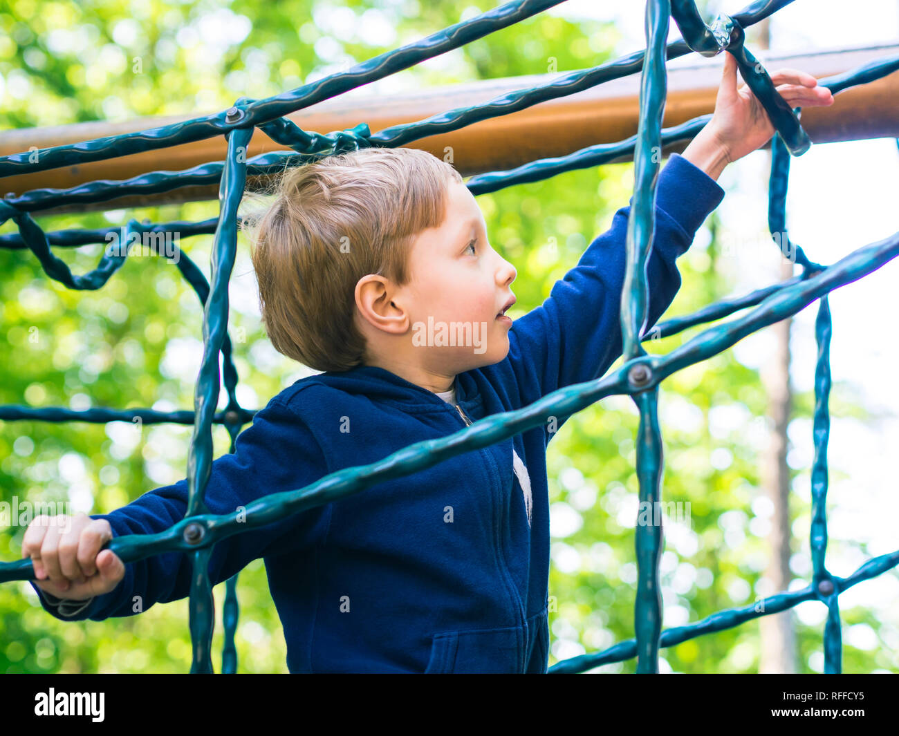Little 5-year old boy playing on a playground. Active happy child Stock ...