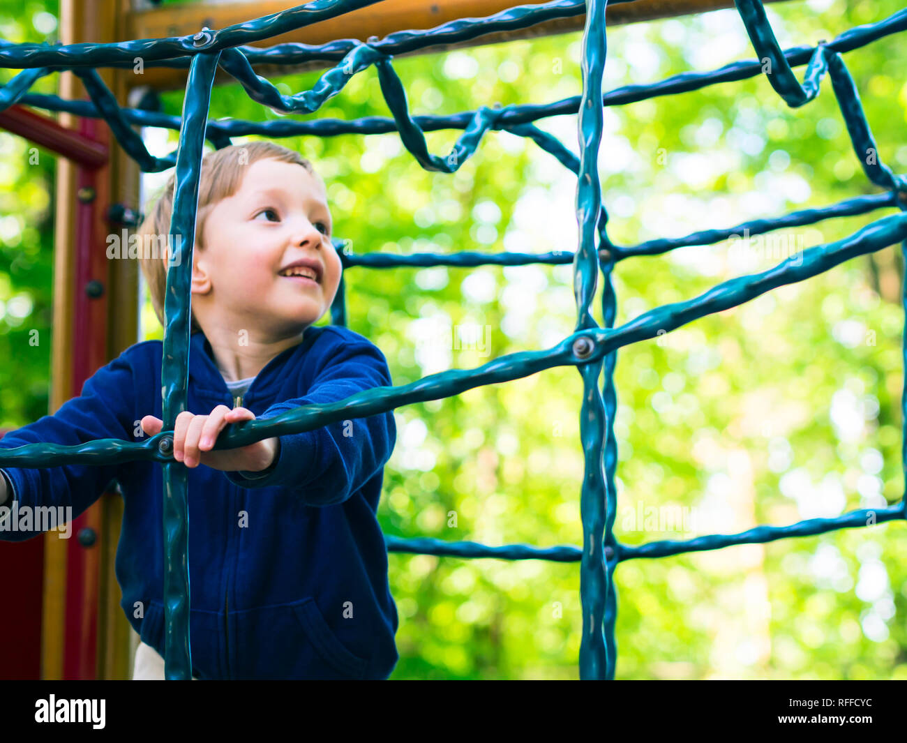 Little 5-year old boy playing on a playground. Active happy child Stock ...