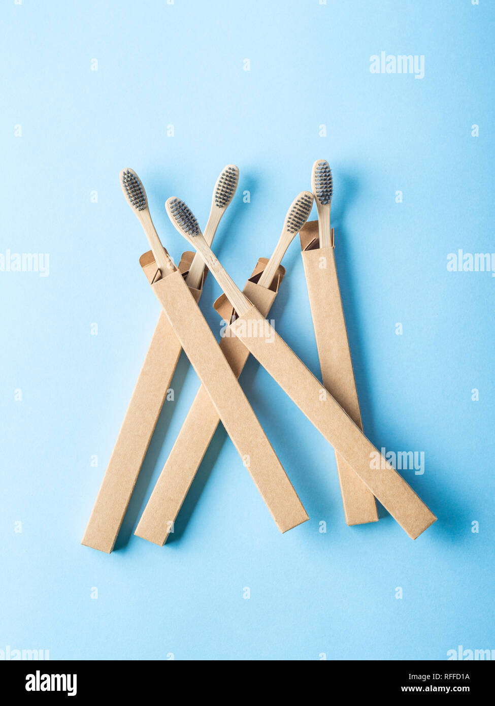 Bamboo biodegradable toothbrushes on blue with eco friendly cardboard ...