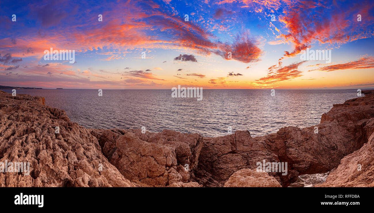 Beautiful colorful sunset at the sea with dramatic clouds and colorful ...