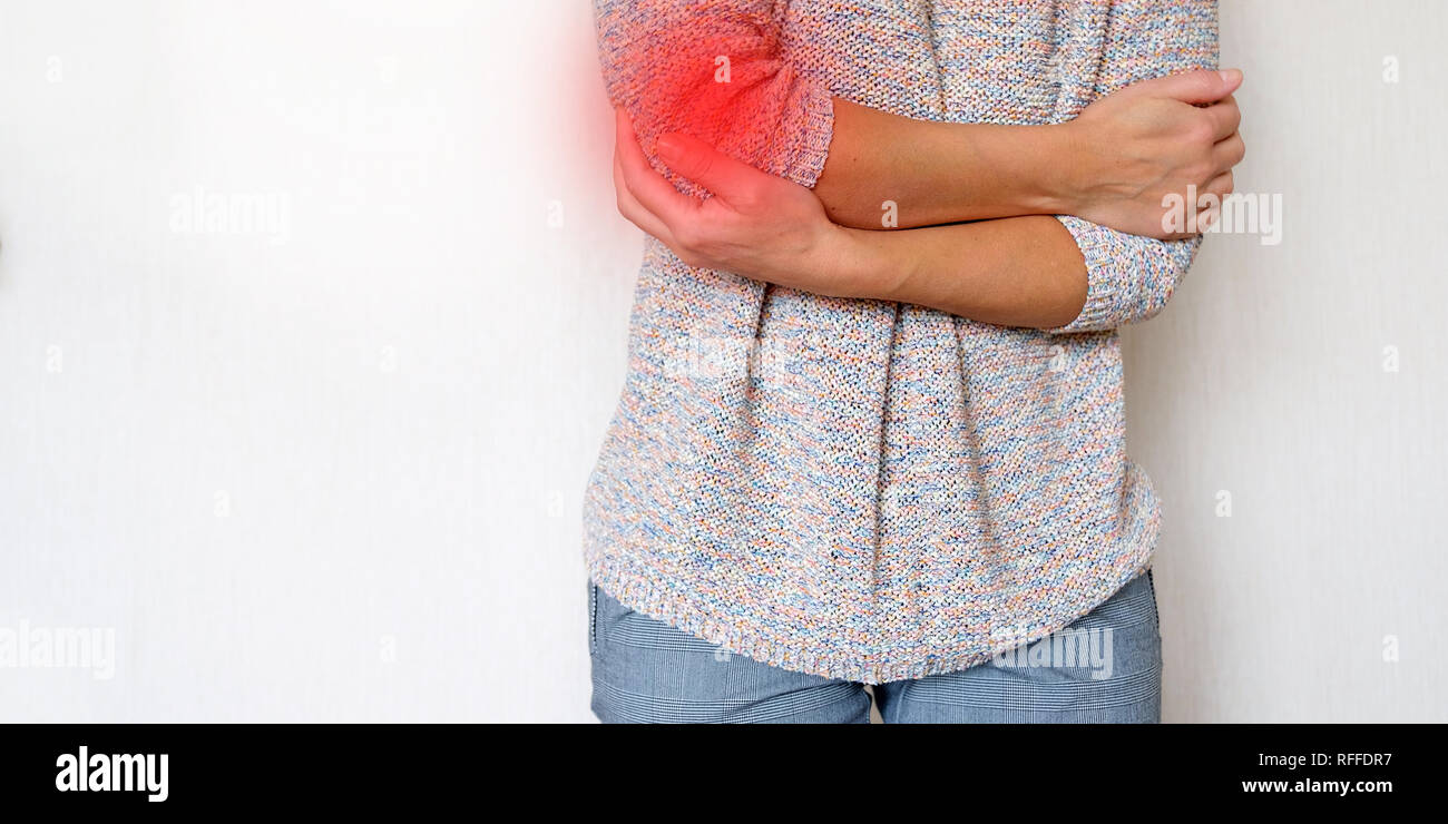 Pain area red background. The girl grabbed his hand in pain. Suffers ...