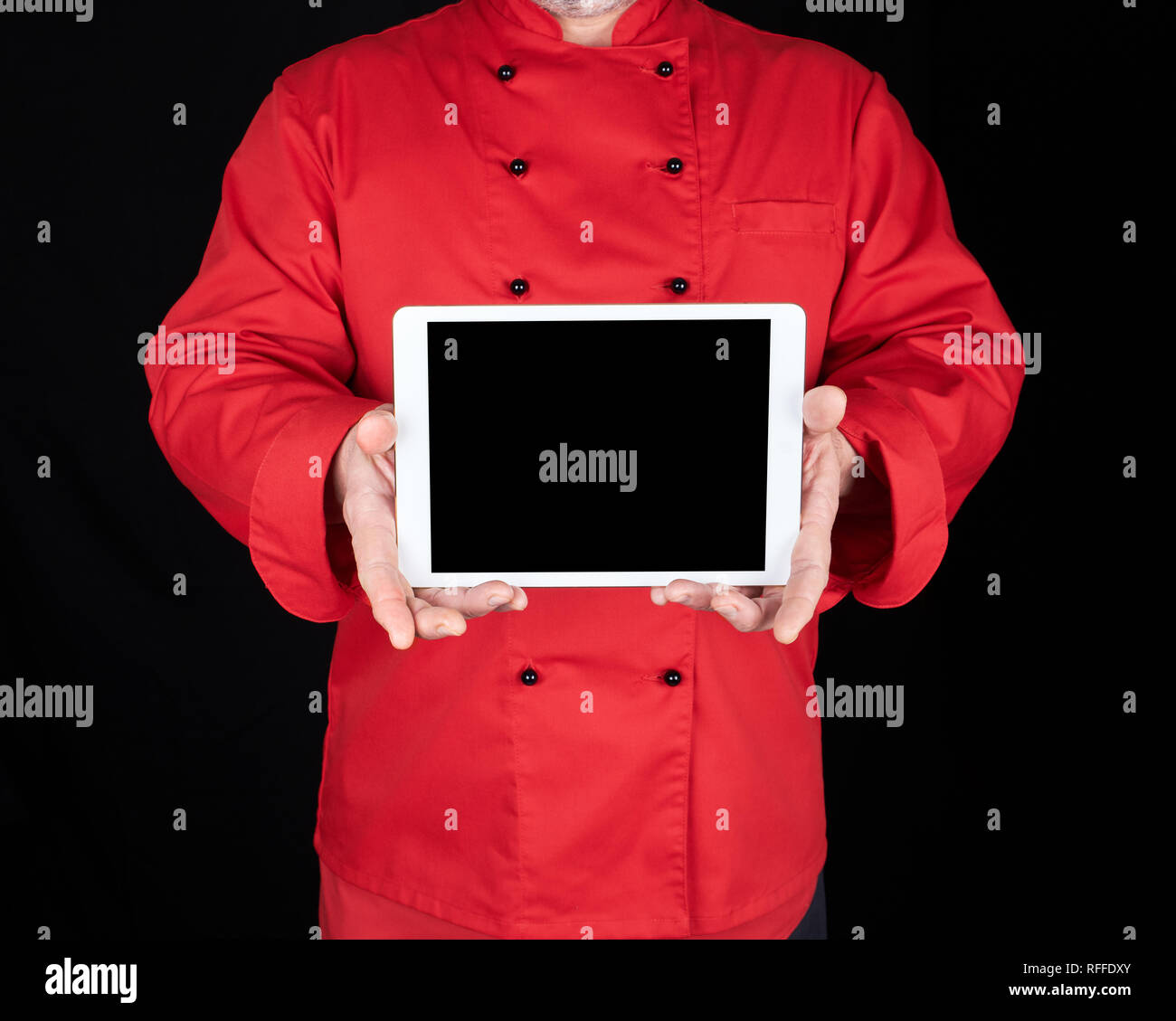 chef in a red uniform holding a white electronic tablet with a black ...