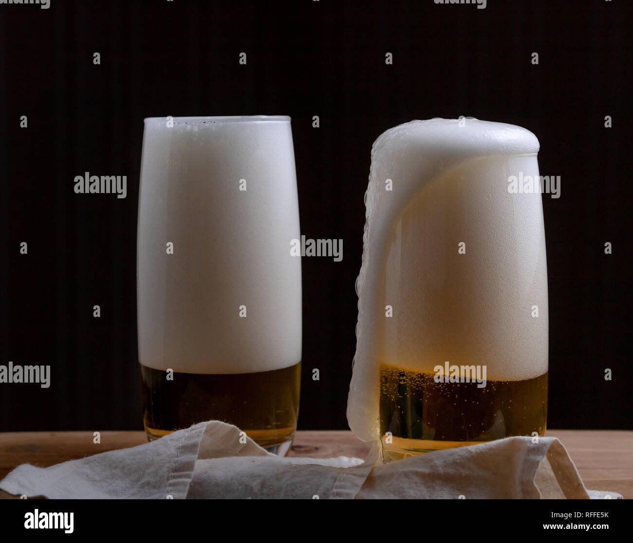 Bubble beer overflowing from the glass Stock Photo - Alamy