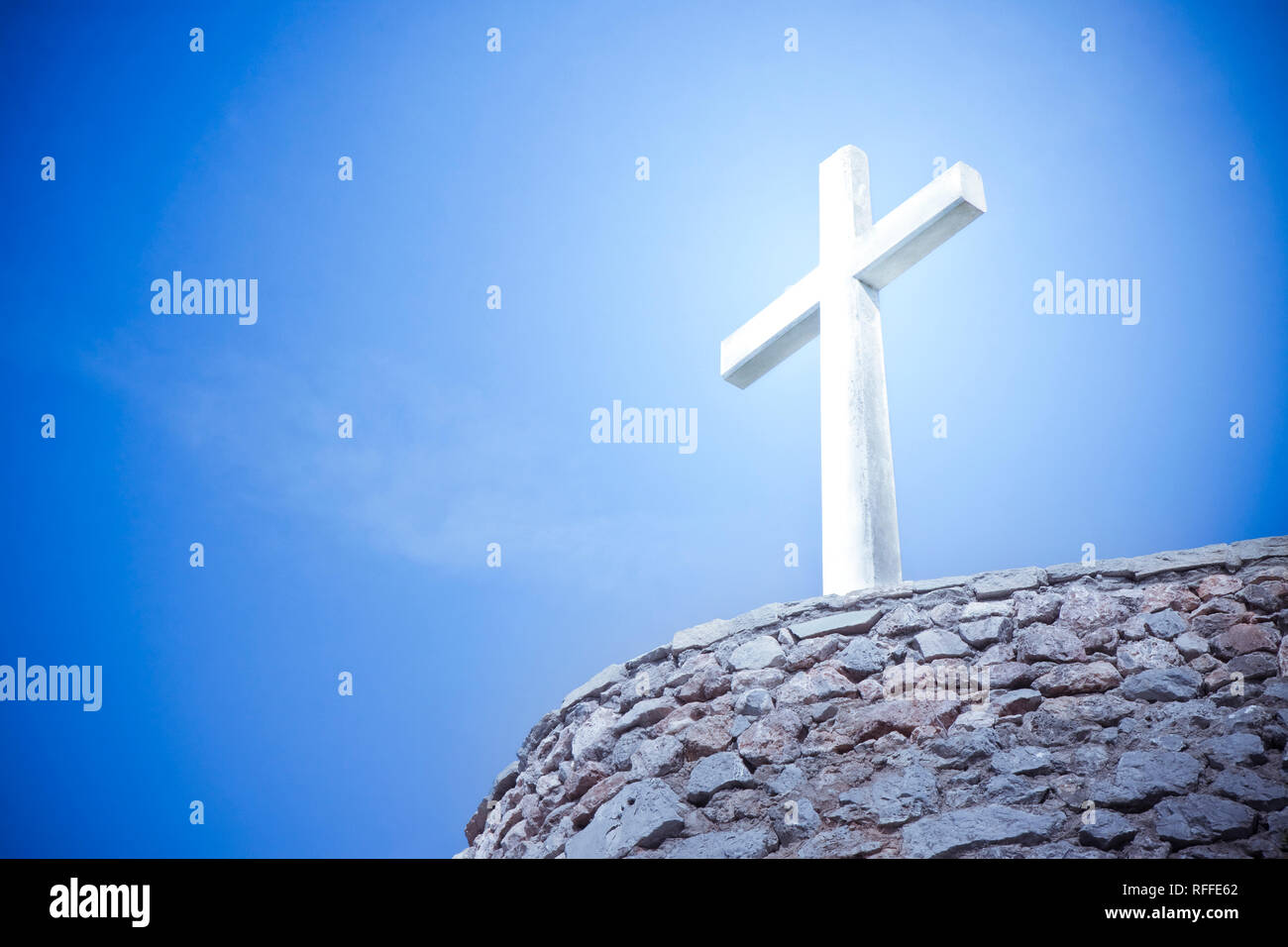 Christian cross in blue background Stock Photo - Alamy