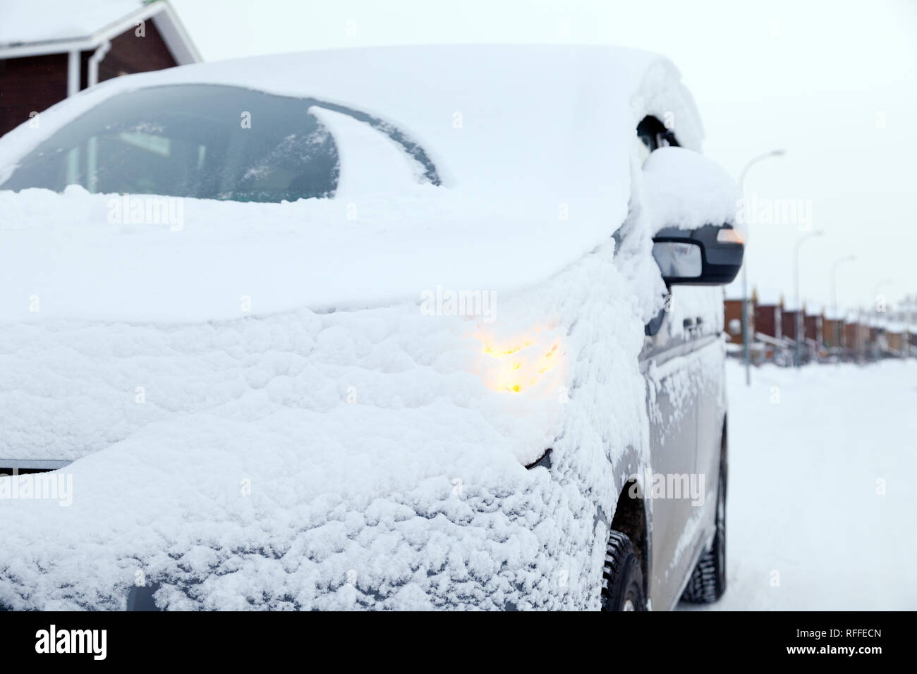 Closeup gray minibus dirty car covered with snow on city background ...