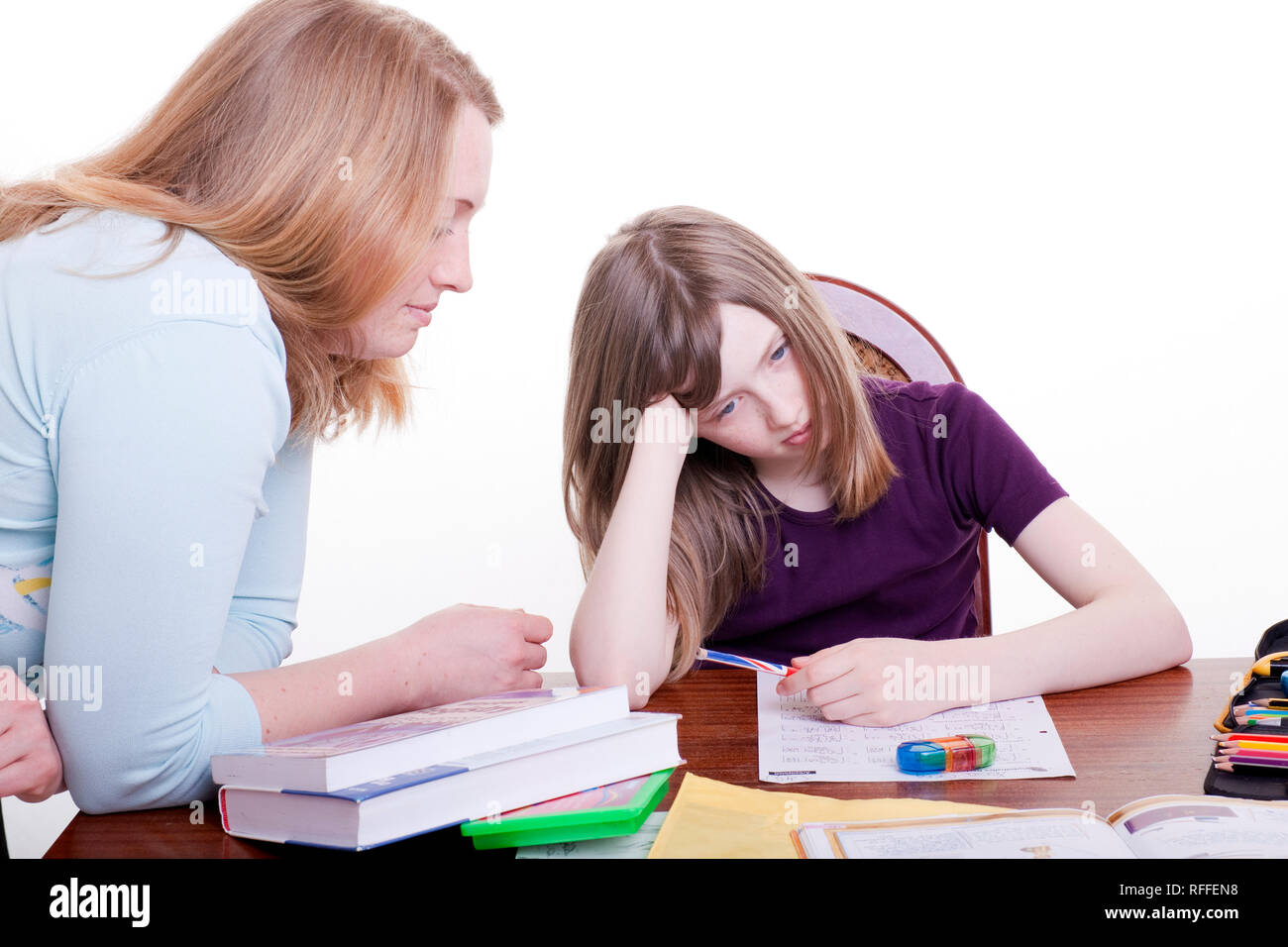A woman helps his child in homework Stock Photo - Alamy