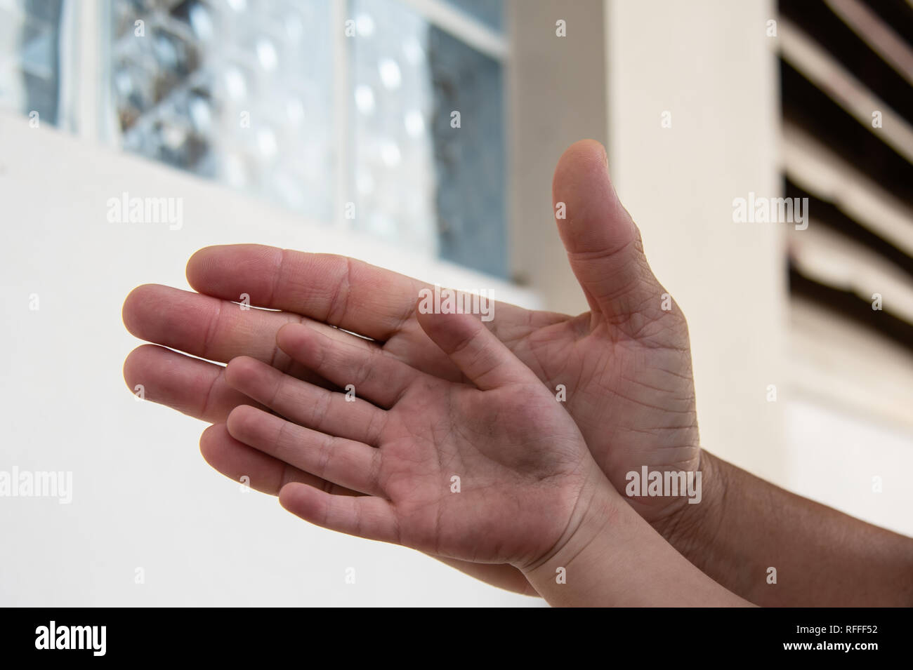 children hand on adult hand for helping Stock Photo - Alamy