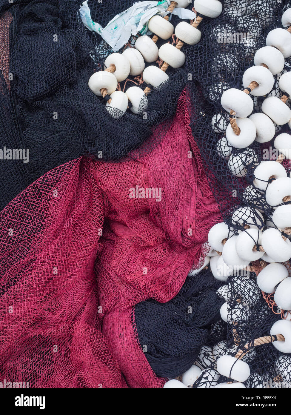 Detail of black and red fishing nets with white floats. traditional ...