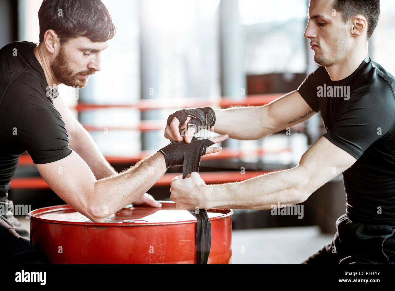 Trainer winding bandage on the wrist for a man, preparing for the ...