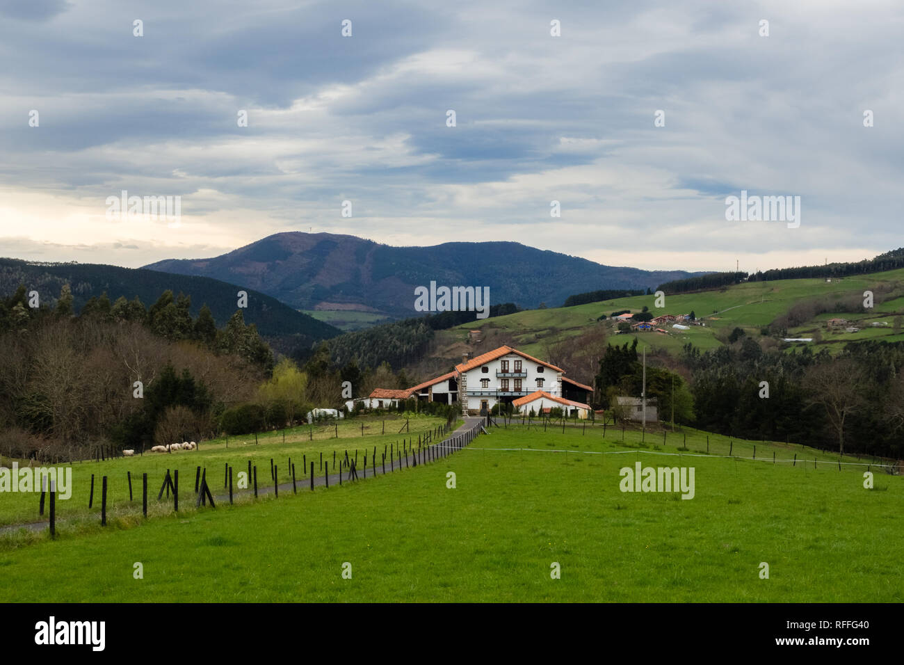 Typical Basque farmhouse with sheep grazing on a cloudy day, Basque ...