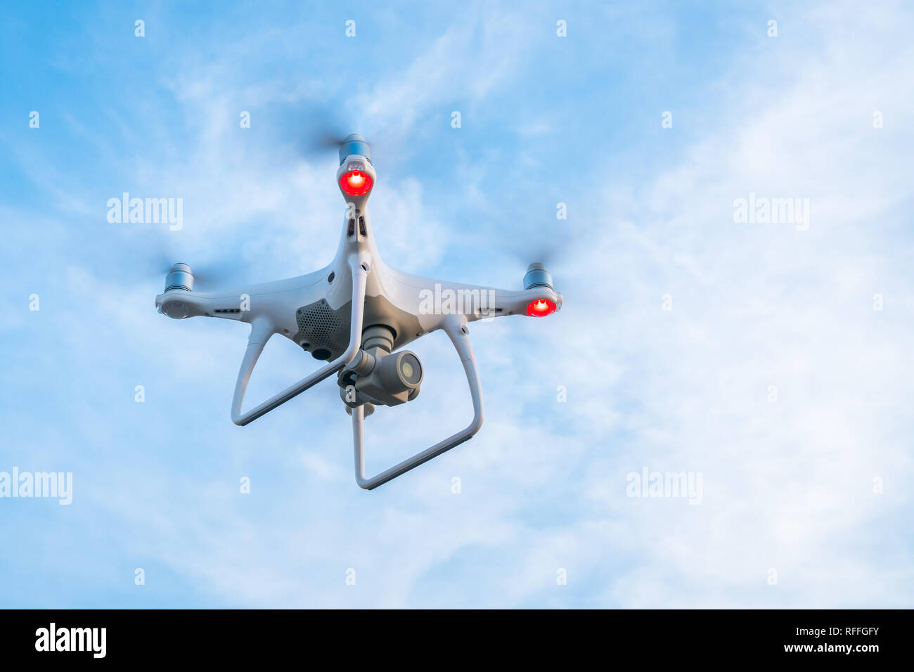 Flying drone with blue sky background Stock Photo - Alamy