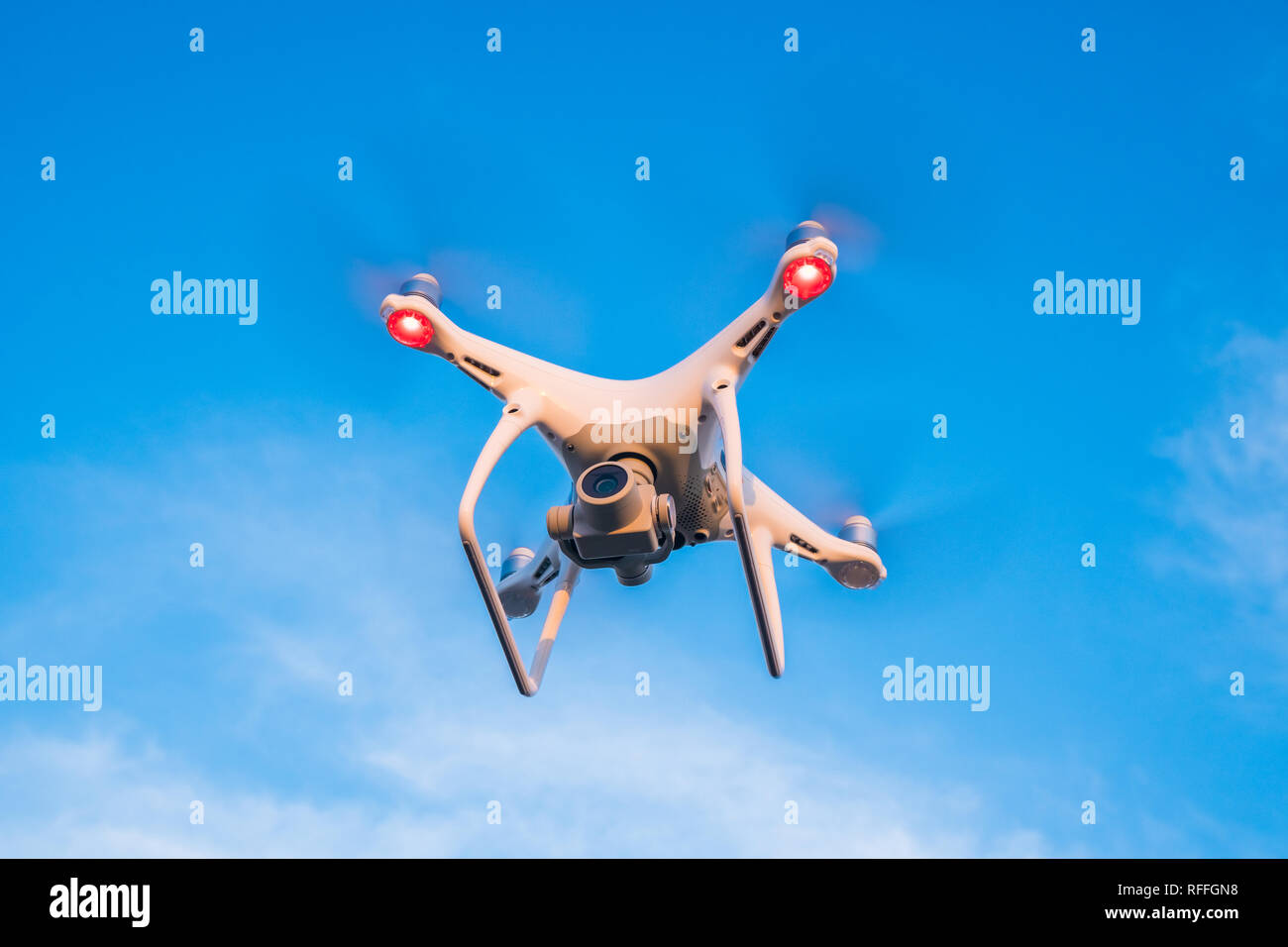 Flying drone with blue sky background Stock Photo - Alamy