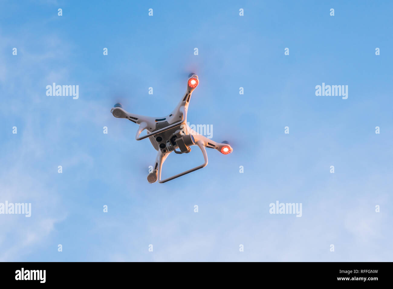 Flying drone with blue sky background Stock Photo - Alamy