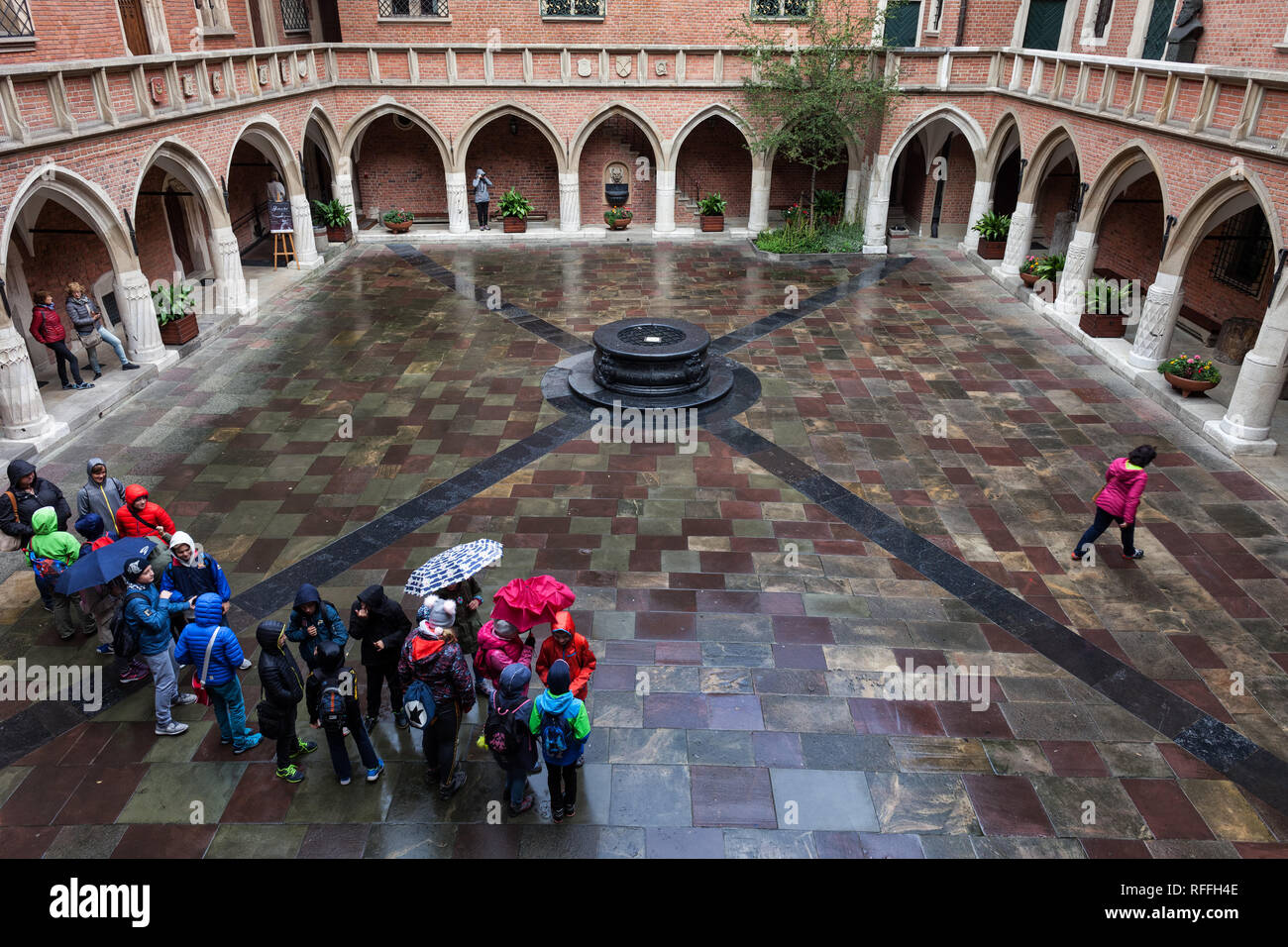 Collegium Maius arcade courtyard with well in city of Krakow in Poland ...