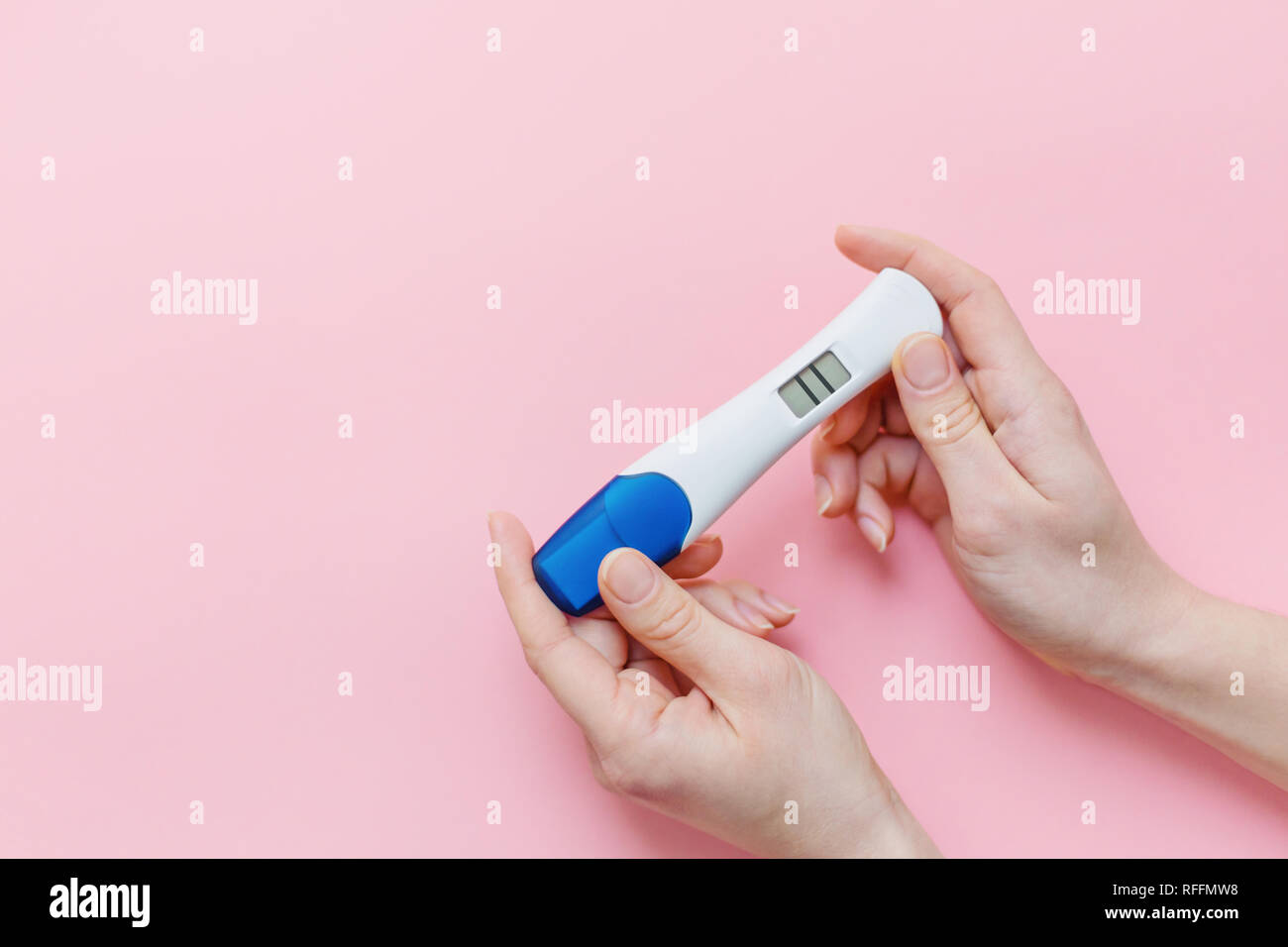 Young woman or girl shows positive pregnancy test with two stripes ...