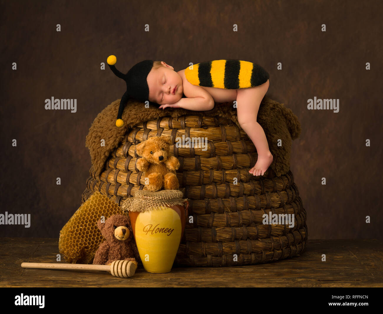 Cute baby sleeping in bee outfit on top of antique beehive Stock Photo ...