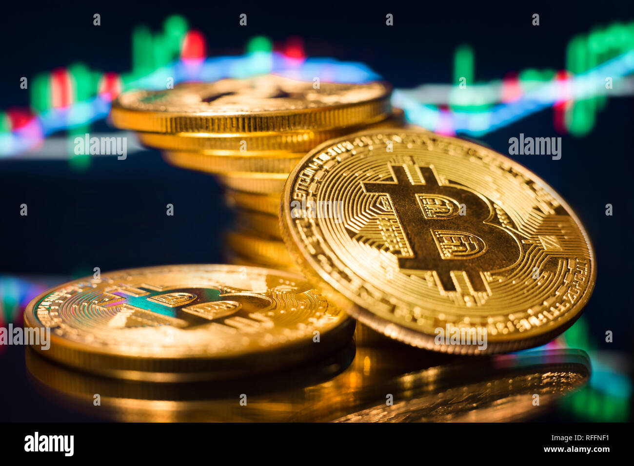 Stack of Bitcoins reflected on shiny black surface and price chart in ...