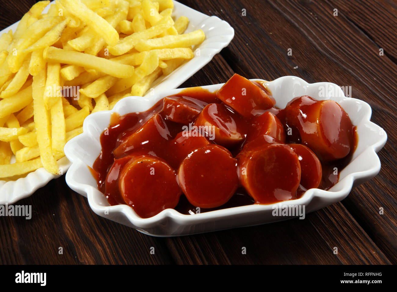 currywurst with fries. traditional german food with sausages and curry ...