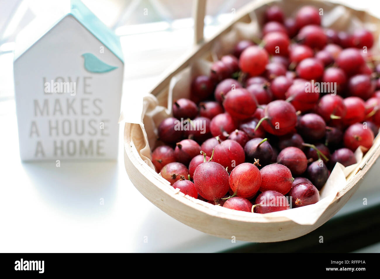 Fresh red dessert gooseberries in a wooden punnet by a window Stock ...
