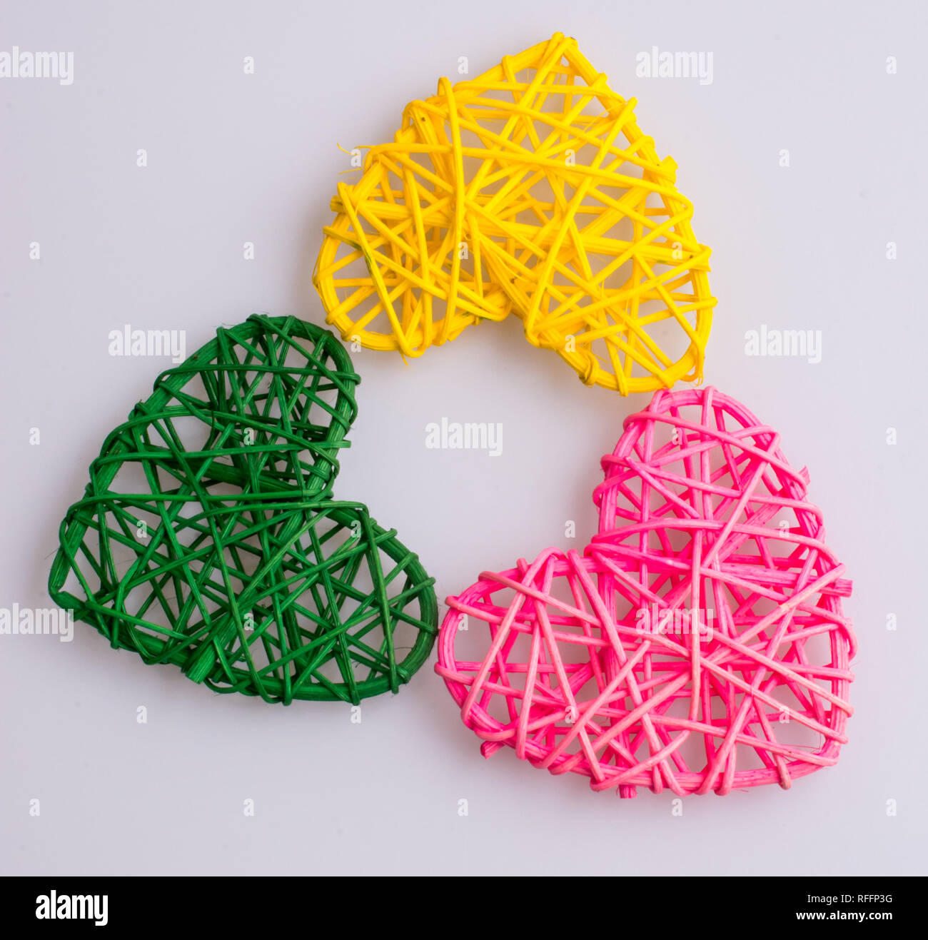 Three colorful straw hearts forming a shape Stock Photo - Alamy