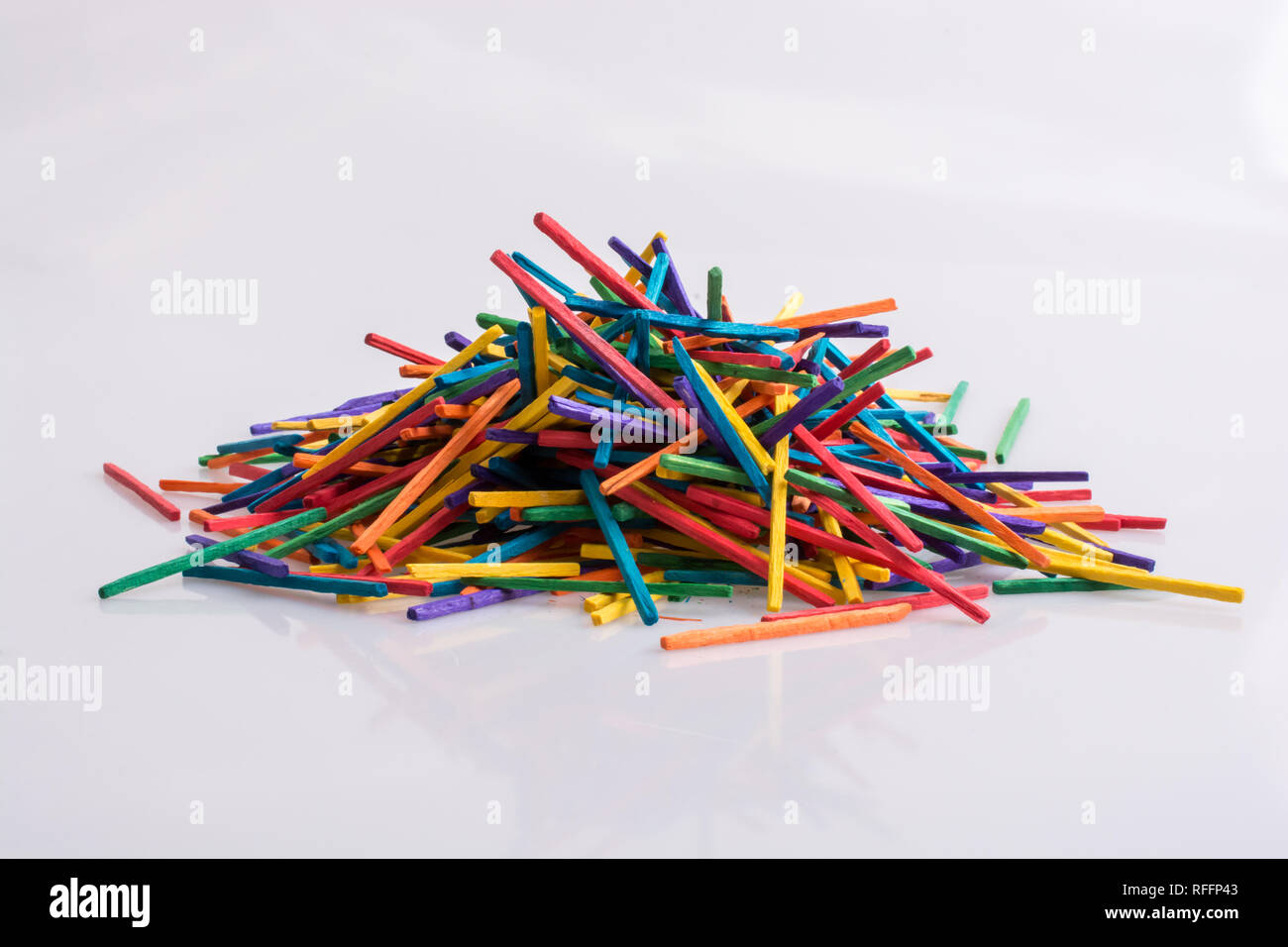 Colorful wooden sticks scatteder on a white background Stock Photo - Alamy