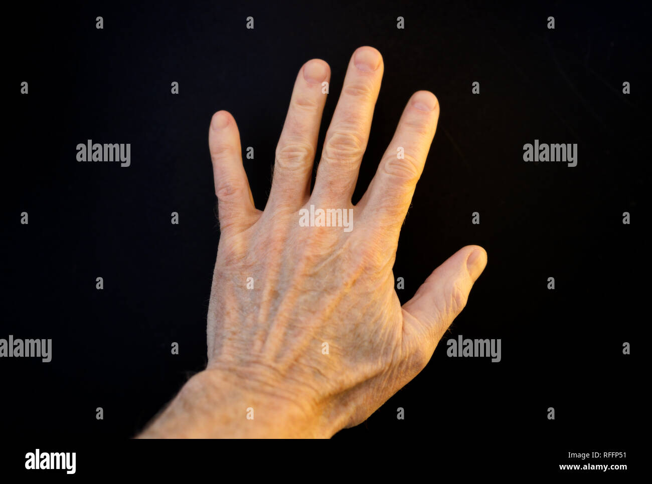 adult male senior hand on black background Stock Photo - Alamy