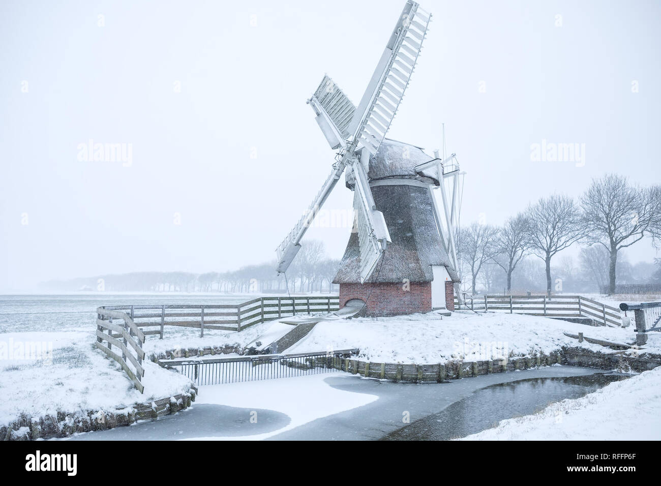 Dutch windmill in snow during winter, Netherlands Stock Photo - Alamy