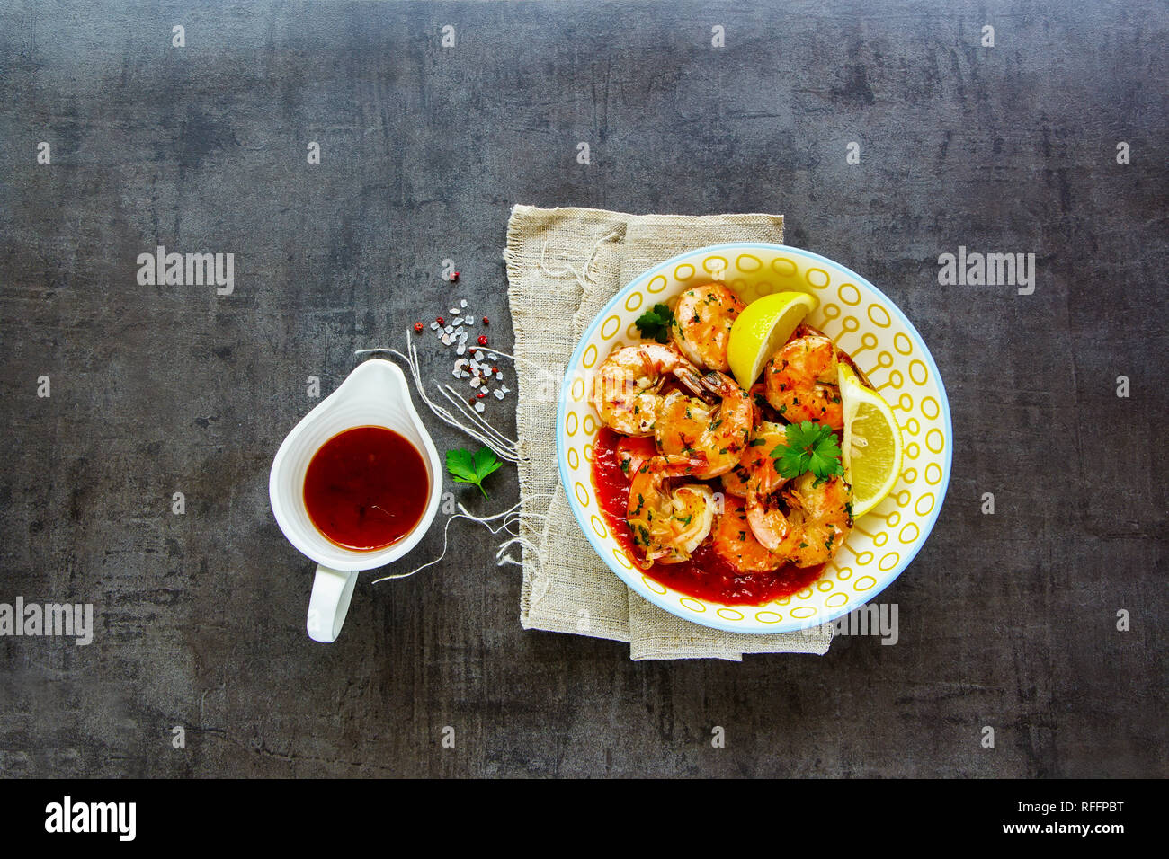Flat lay of delicious grilled pink Prawn Shrimp with lemons and sauce ...