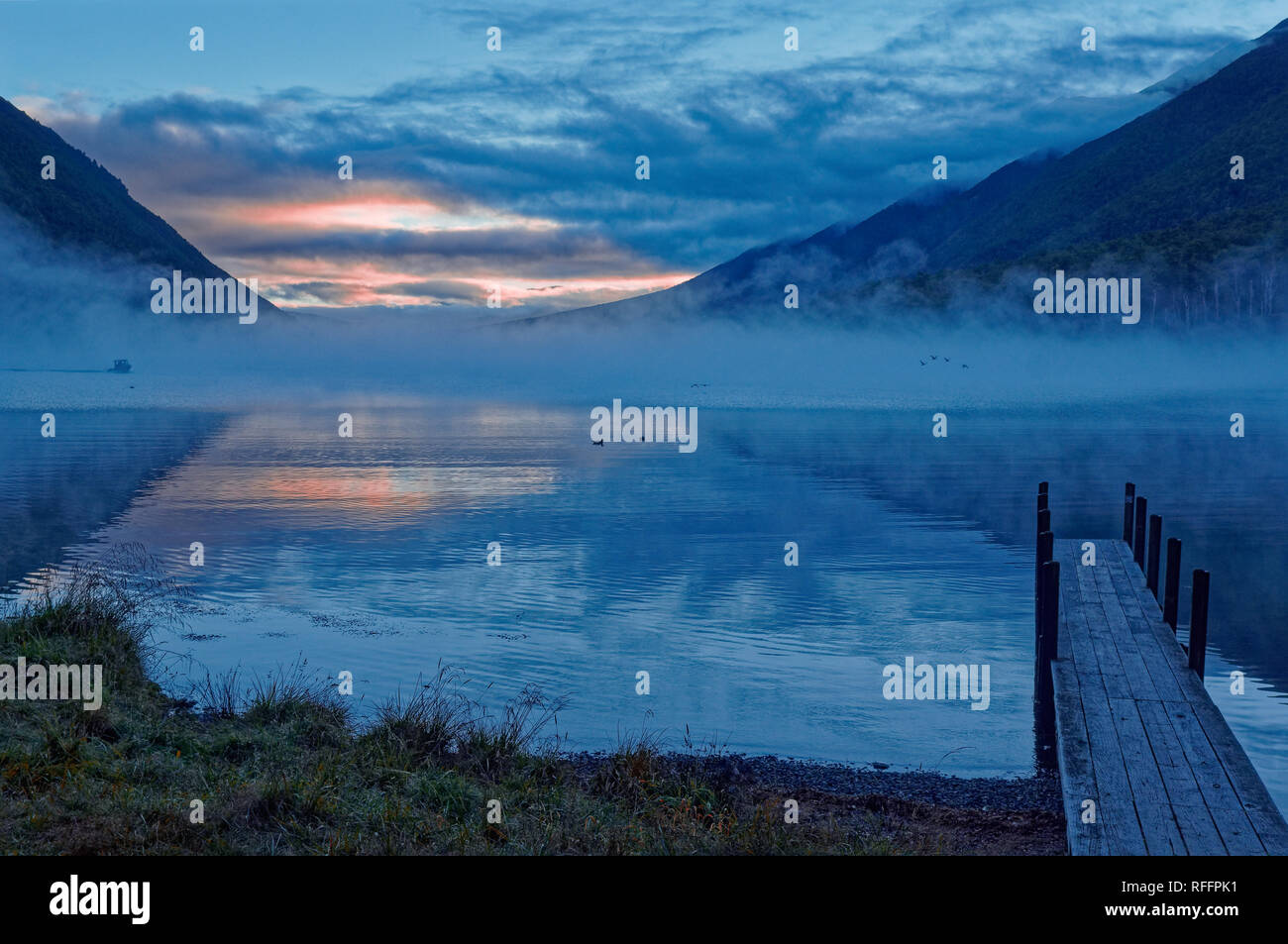 Sunrise over Lake Rotoiti from Coldwater hut boat jetty at Nelson Lakes ...